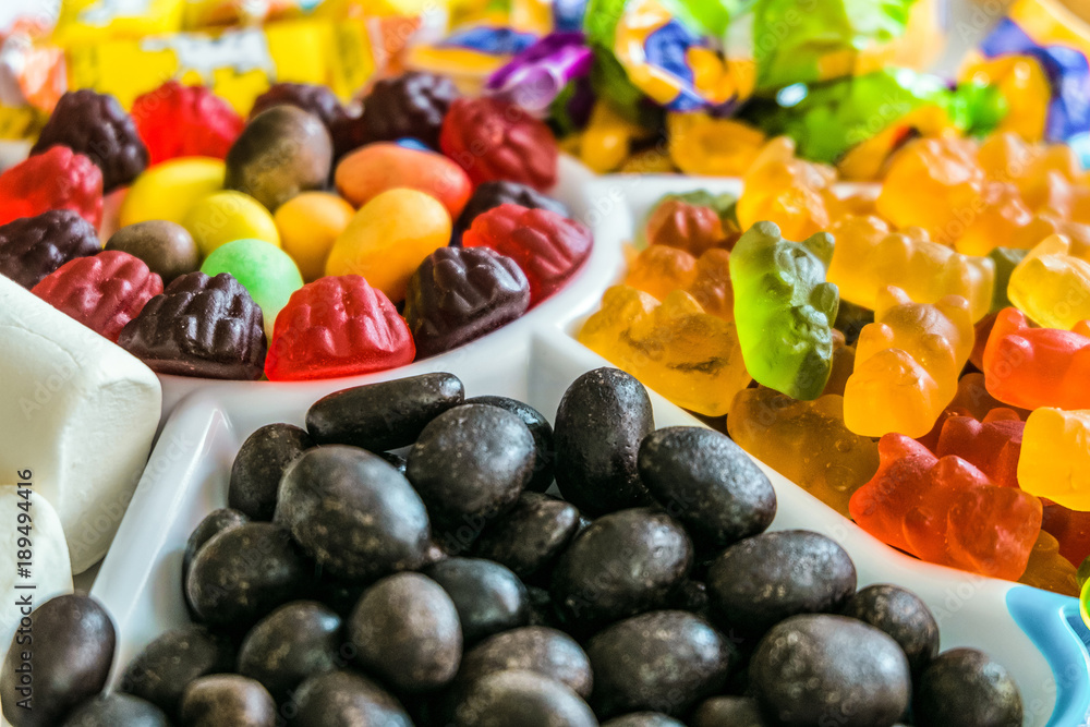Set of sweet loose candies in a tray. Heaps of peanuts in chocolate ...
