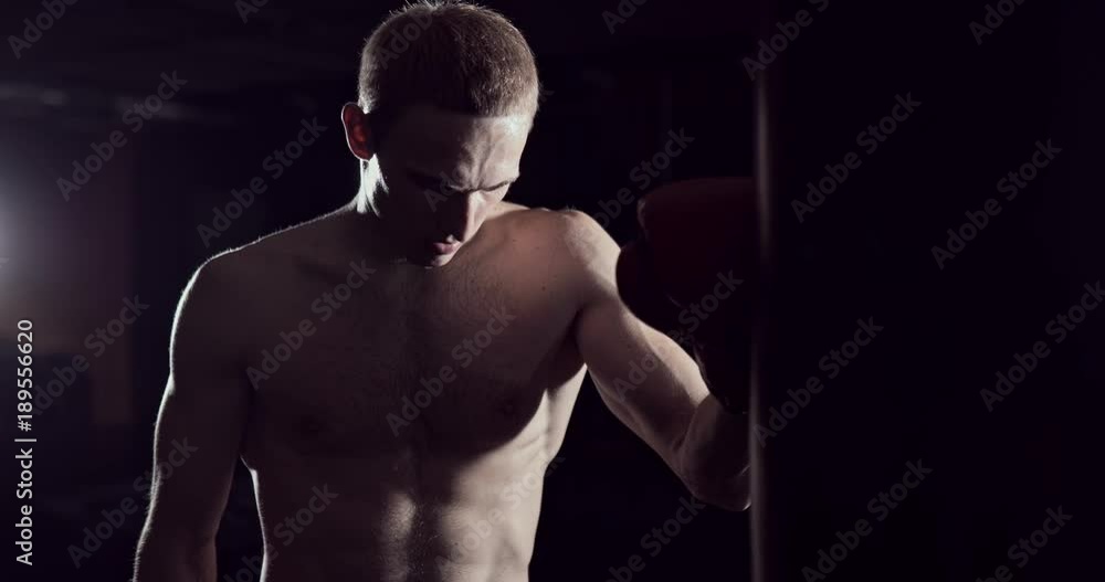 Kickboxer tired after strength training exercise at gym. Tired man ...