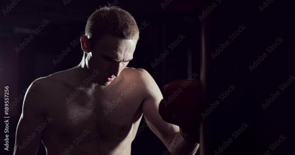 Kickboxer tired after strength training exercise at gym. Tired man ...