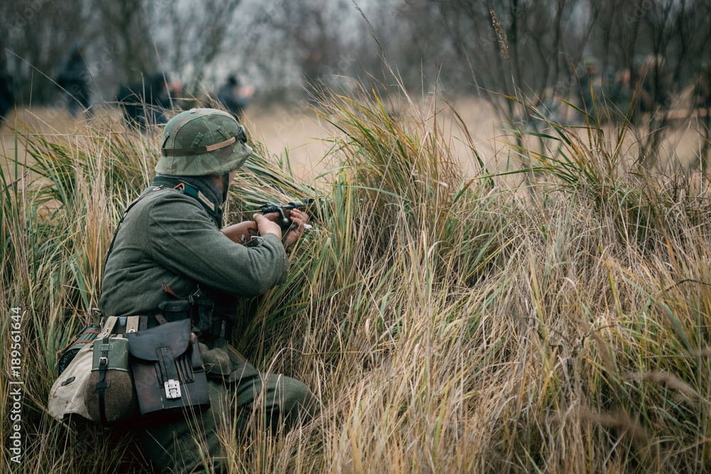 German soldier Wehrmacht sits in hiding with a rifle Stock Photo ...