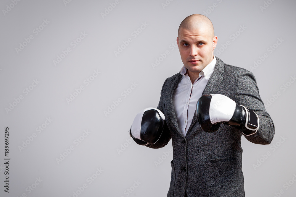 Young bald man, confident manager in white shirt, gray suit and boxing ...
