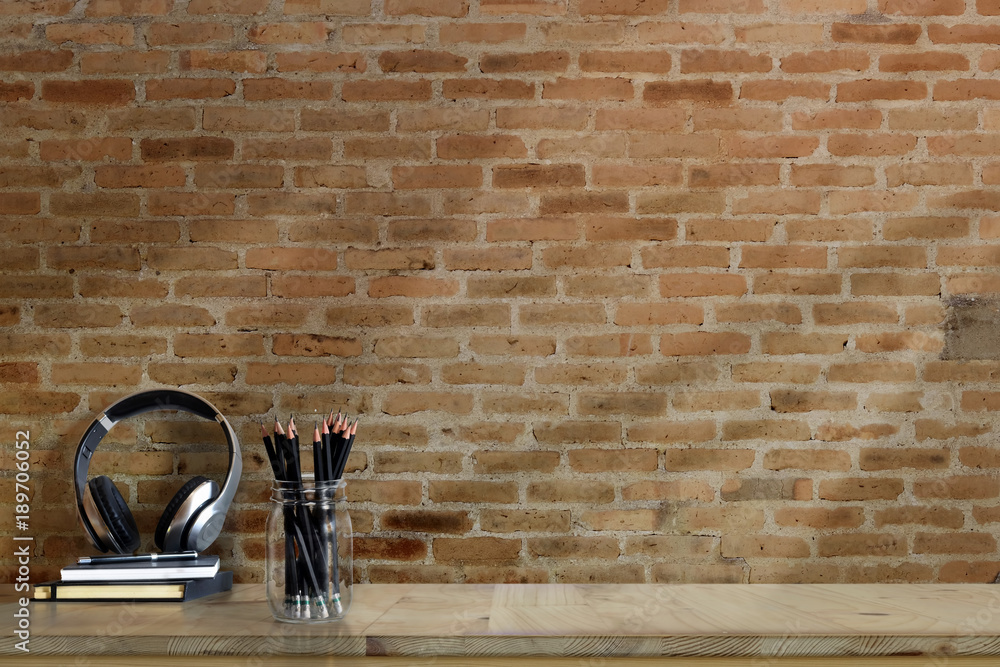 Front view of stylish desk and red brick wall. copy space for product ...