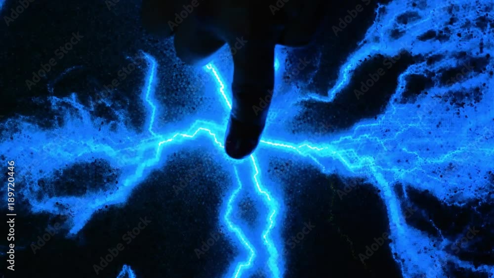 Abstract blue lightning. A man touches his hand to electricity. Aura ...