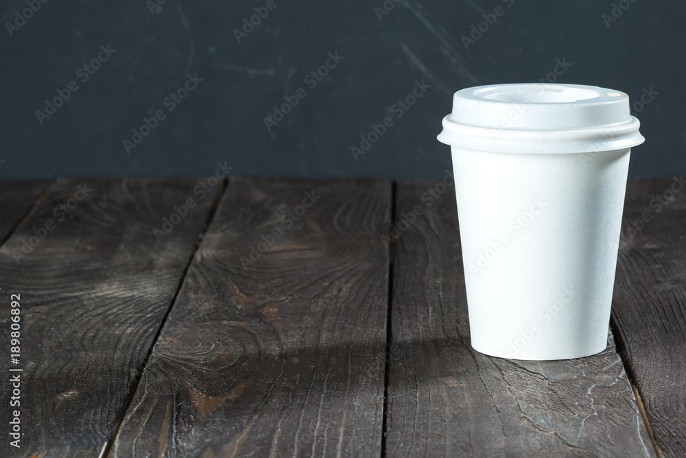 white paper cup/ Background of a wooden countertop with a white paper ...