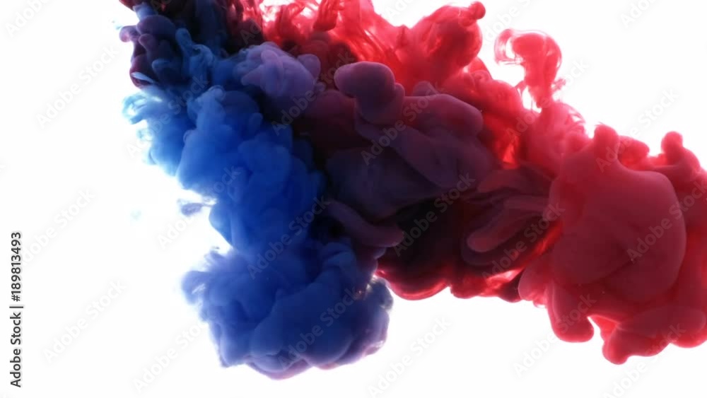 Color paint drops in water in slow motion. Ink swirling underwater ...