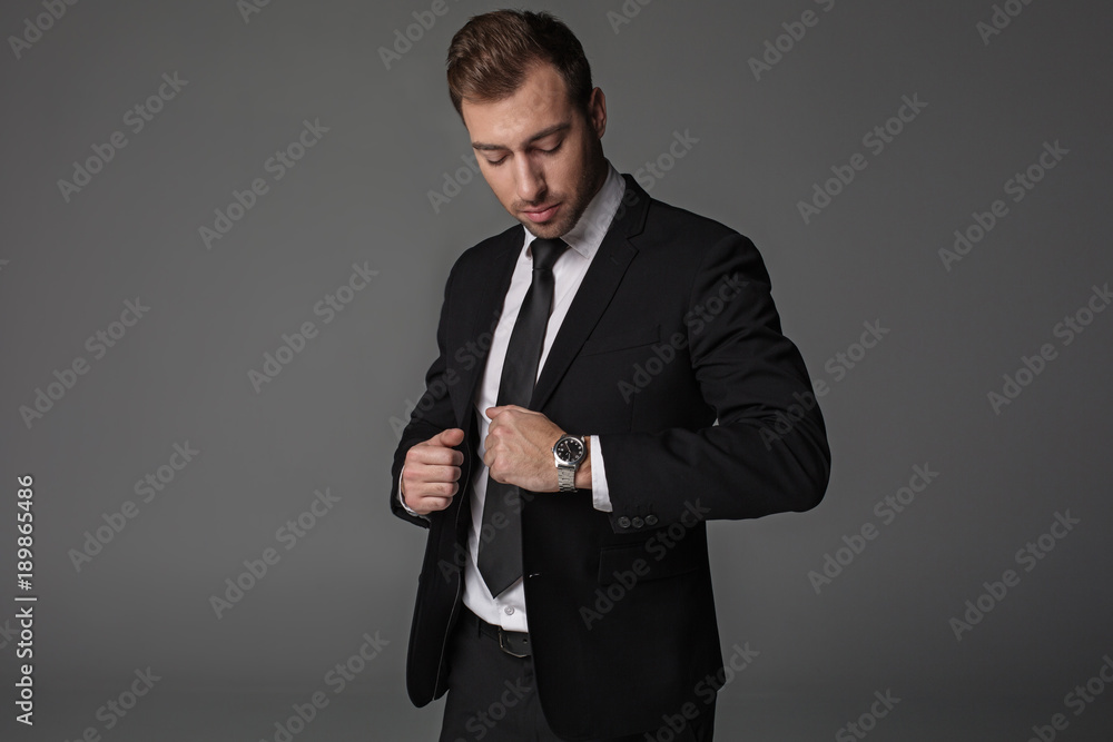 Portrait of calm businessman looking at watch. It locating on arm. Time ...
