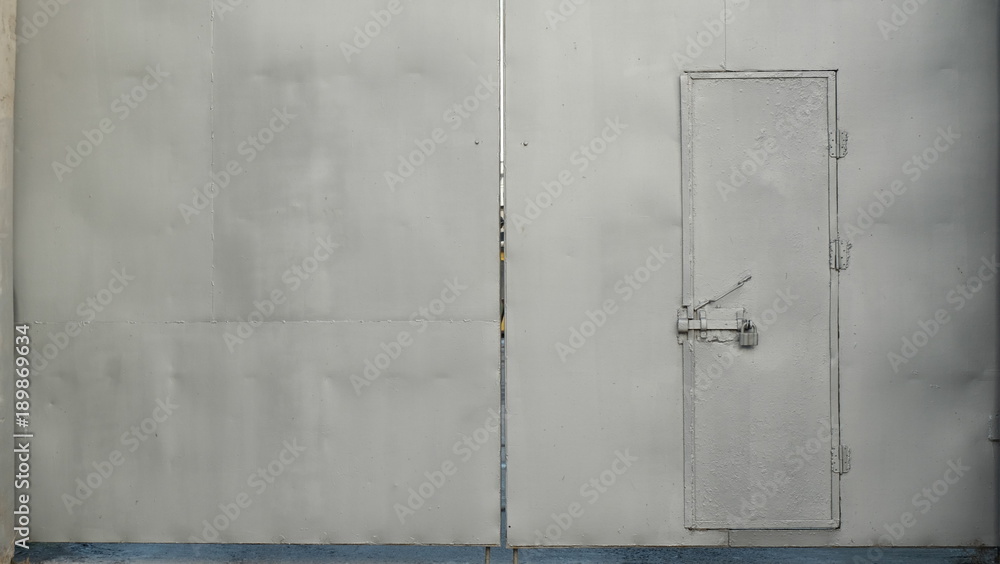 Silver gate with a gate with a lock. Stock Photo | Adobe Stock