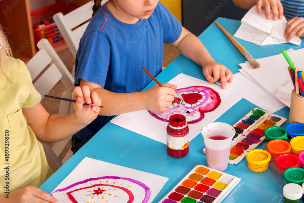 Small students painting in art school class. Child drawing paints on ...