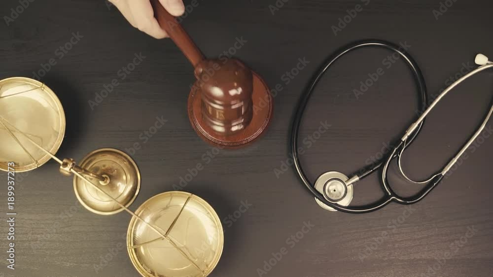 top view of judge hand striking mallet with stethoscope at desk in ...