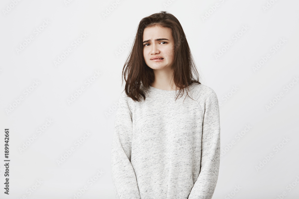 Portrait of cute european student who shows disagreement and disgust of ...