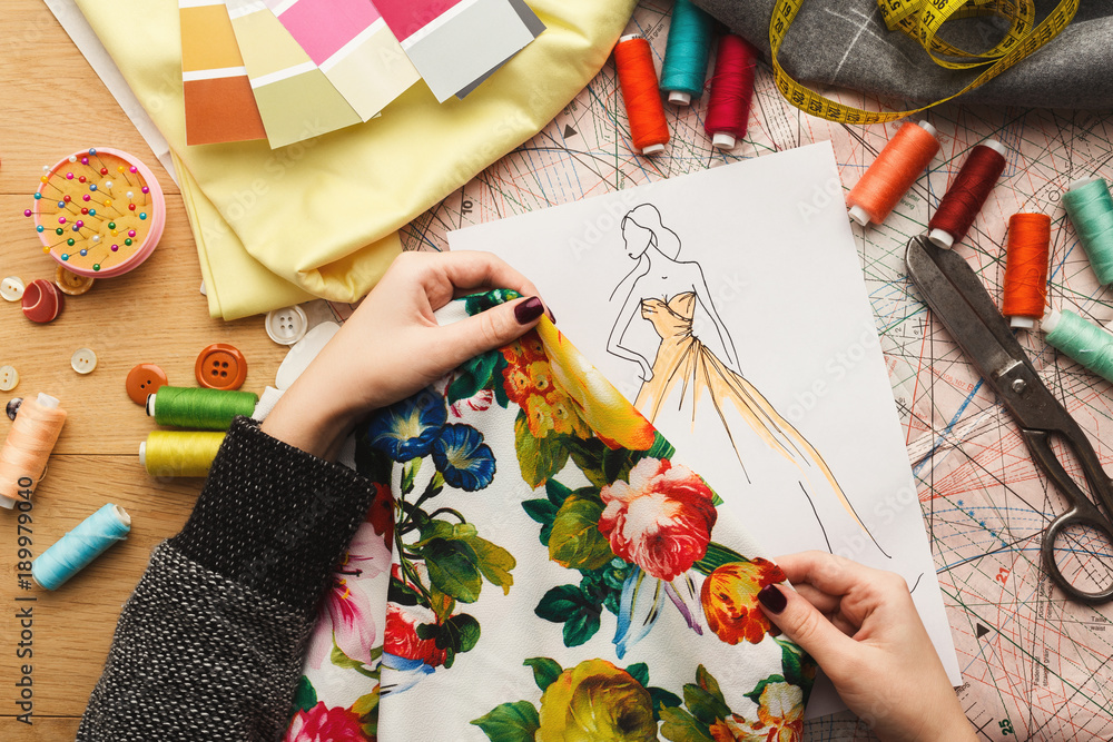 Female fashion designer working with fabric sample and drawn ...
