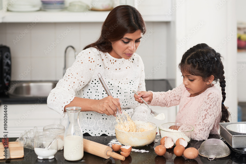Indian Family Wrapped up in Cooking Stock Photo | Adobe Stock