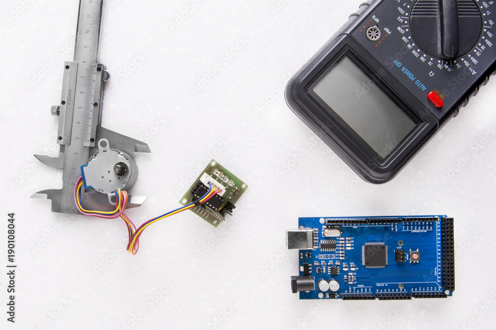 Arduino Mega Board Flat Layout With Caliper Stepper Motor And Multimeter On A Marble Background