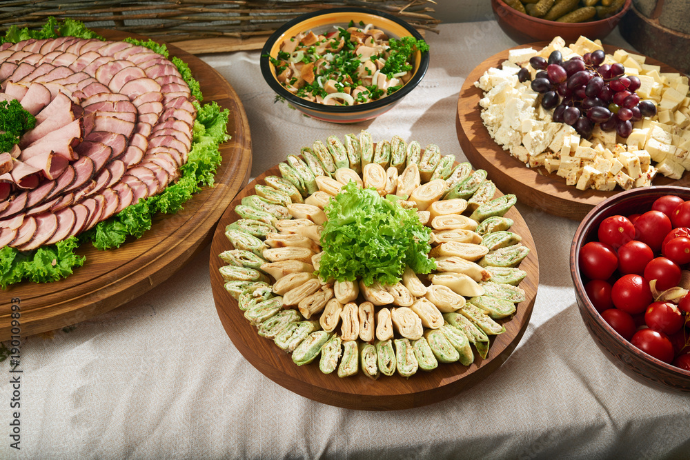 Restaurant table full of different appetizers: tapas rolls with ...