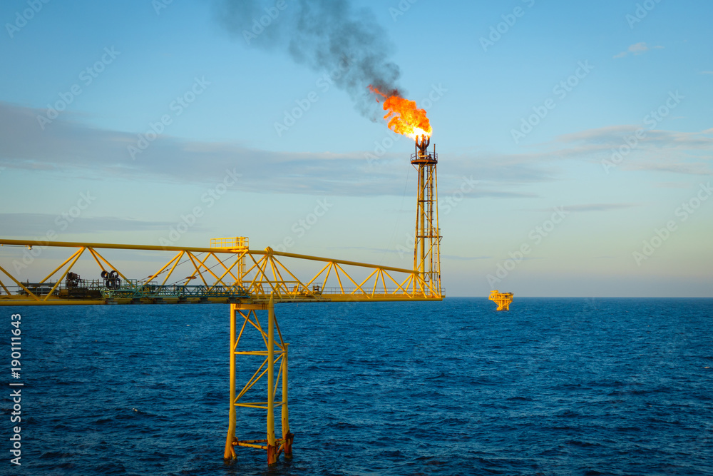 Gas is releasing and burning to the atmosphere from flare bridge of ...