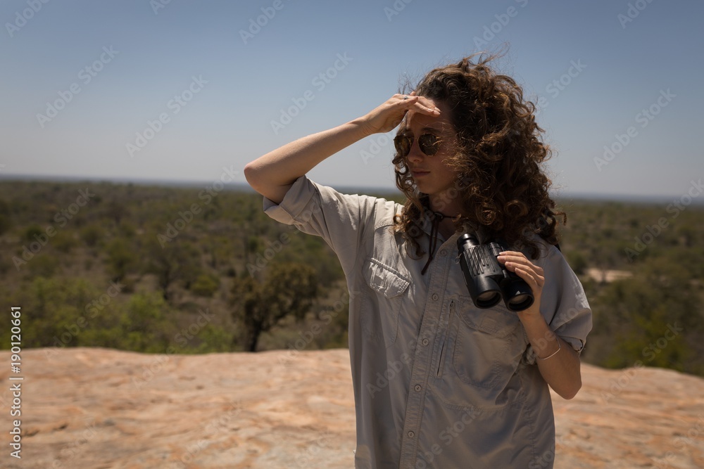 Beautiful woman shielding her eyes from sun Stock Photo | Adobe Stock