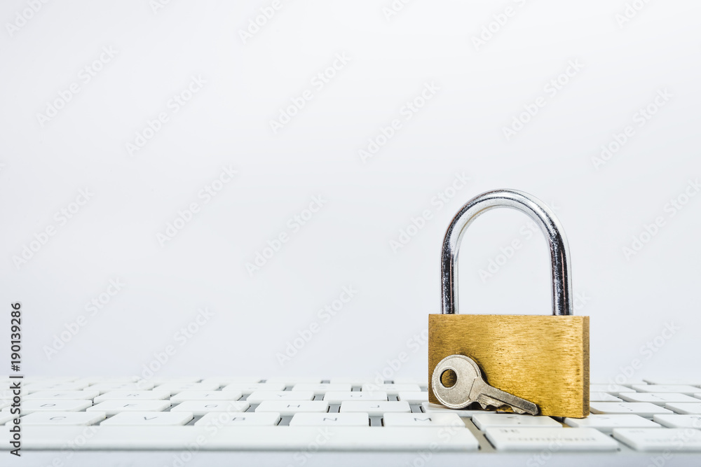 Background image of golden metal lock and key on keyboard Stock Photo ...