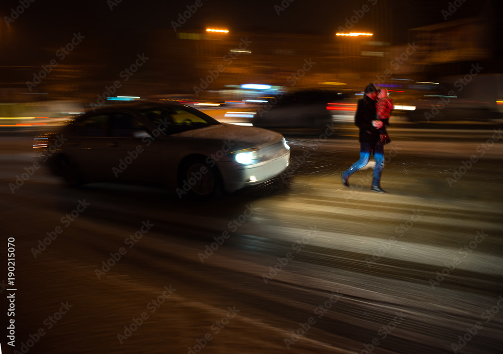 Father with a child in his arms on zebra crossing at night Stock-Foto ...