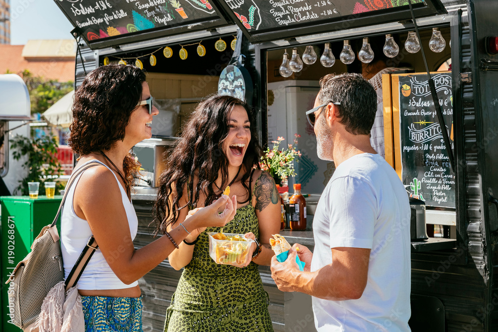People eating snacks at food truck Stock-Foto | Adobe Stock