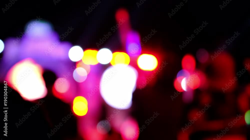 crowd of people silhouettes with their hands up, concert spotlights ...