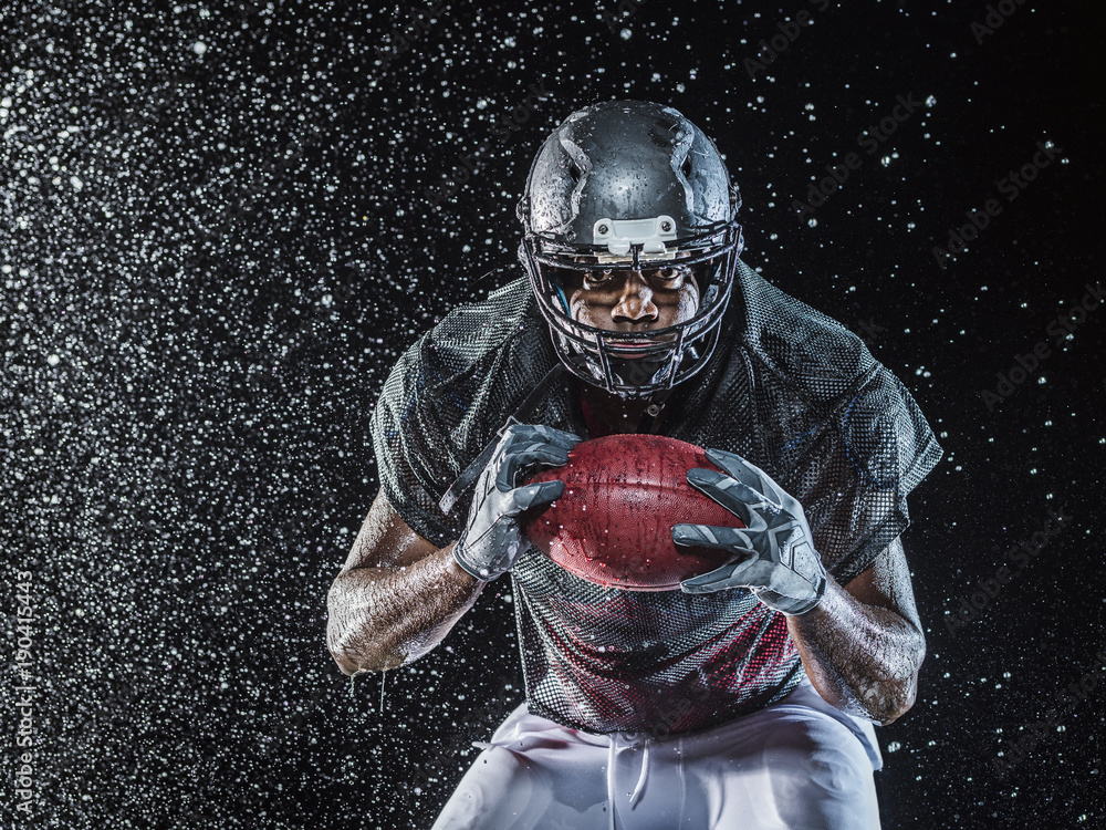 Water splashing on football player Stock Photo | Adobe Stock