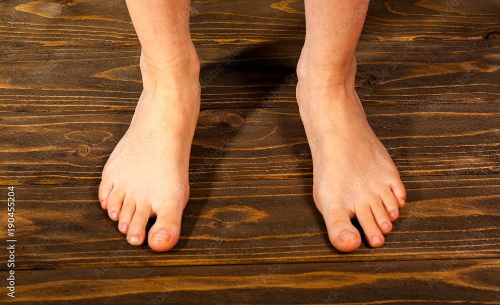 young girl steppe feet with itchy feet uses his big toe to scratch his ...