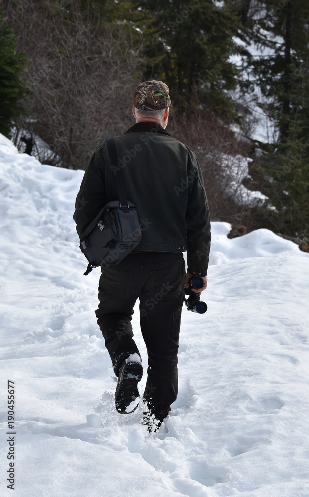 Man hiking through snow Stock Photo | Adobe Stock