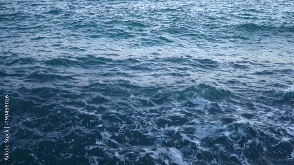 Texture of the surface of the dark surface of the sea. Small waves on ...