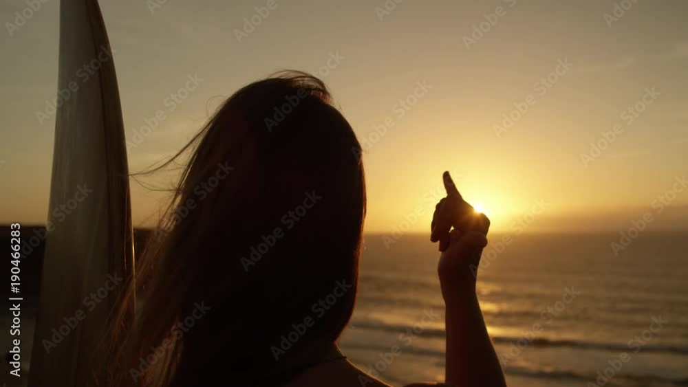 SLOW MOTION CLOSE UP: Unrecognizable girl with long flowing hair gazing ...