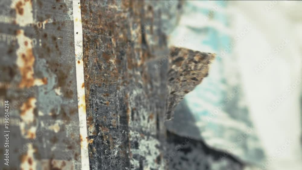 The texture of a wall with torn posters and ads. Broken posters sway in ...