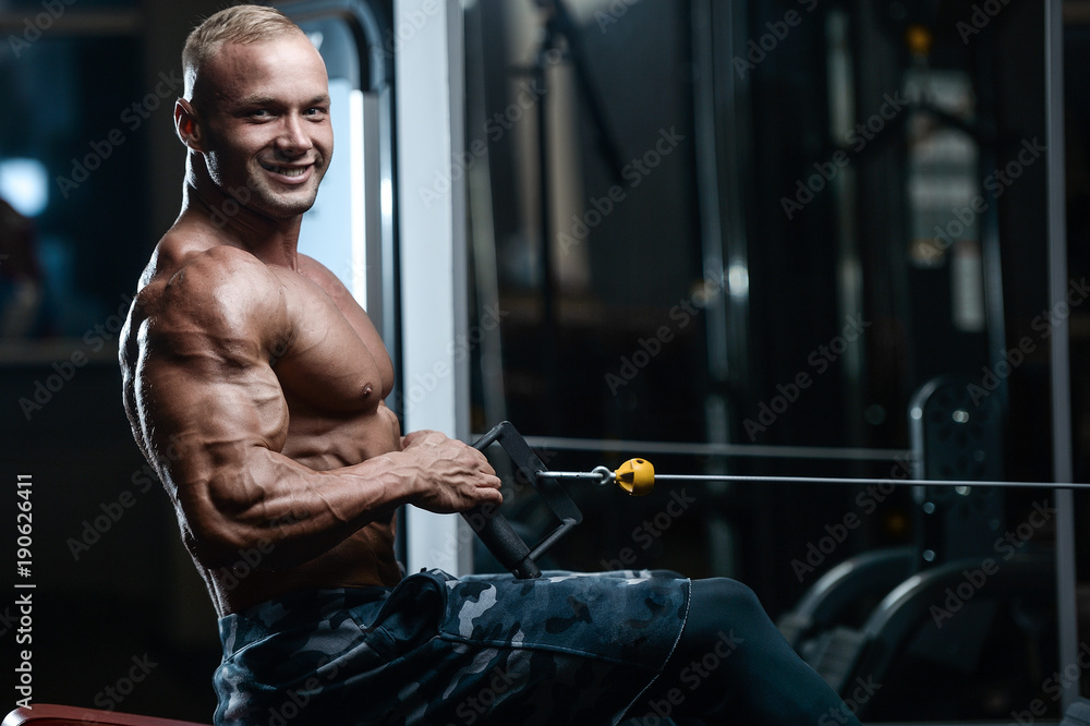 Brutal strong bodybuilder athletic men pumping up muscles with ...