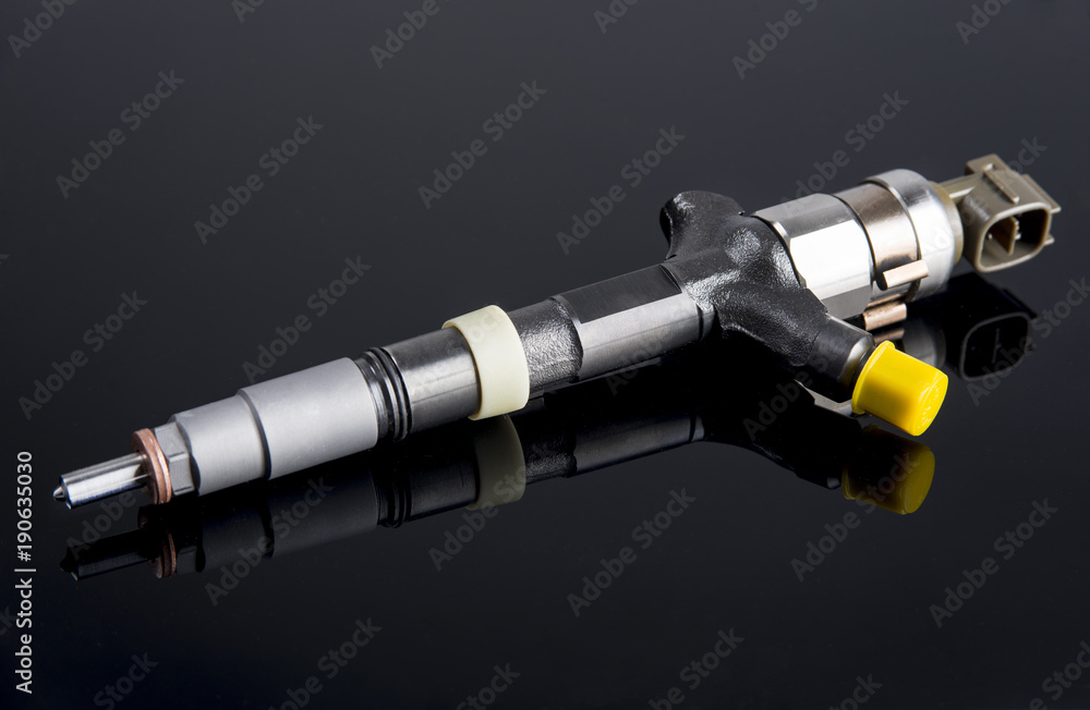 Diesel fuel injector isolated on black Stock Photo | Adobe Stock