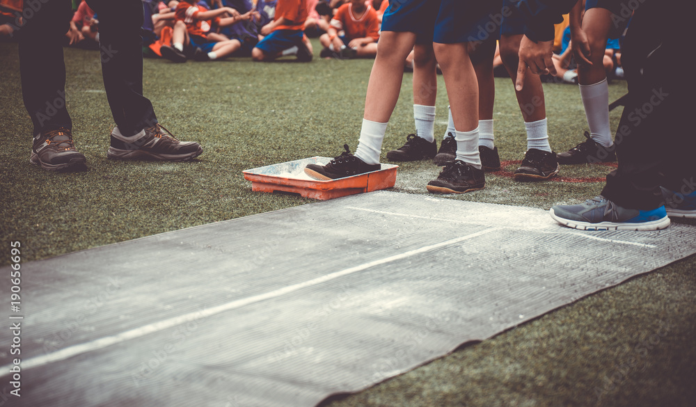 Students boy prepare himself for long jump competition at school sports ...
