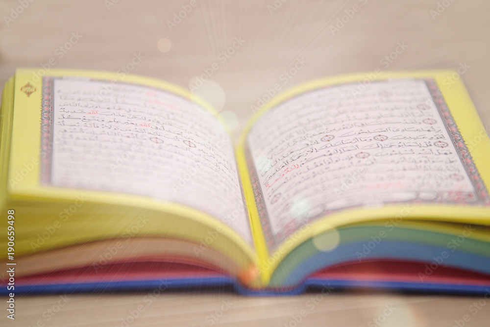 The holy Quran with optical lens flares and colored sheets Stock Photo ...