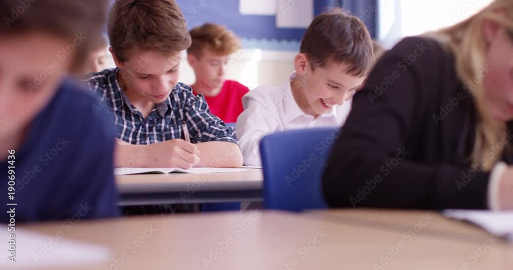 4k, Two students helping each other in a school classroom. Slow motion ...