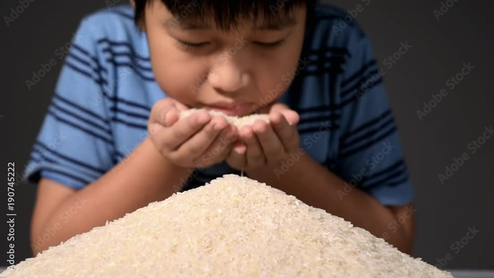 Preteen Asian Thai boy smelling the white rice grain. Stock Video ...