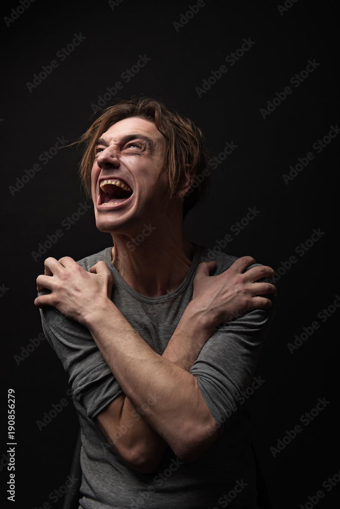 Waist up portrait of sick depressed man sitting with arms crossed on ...