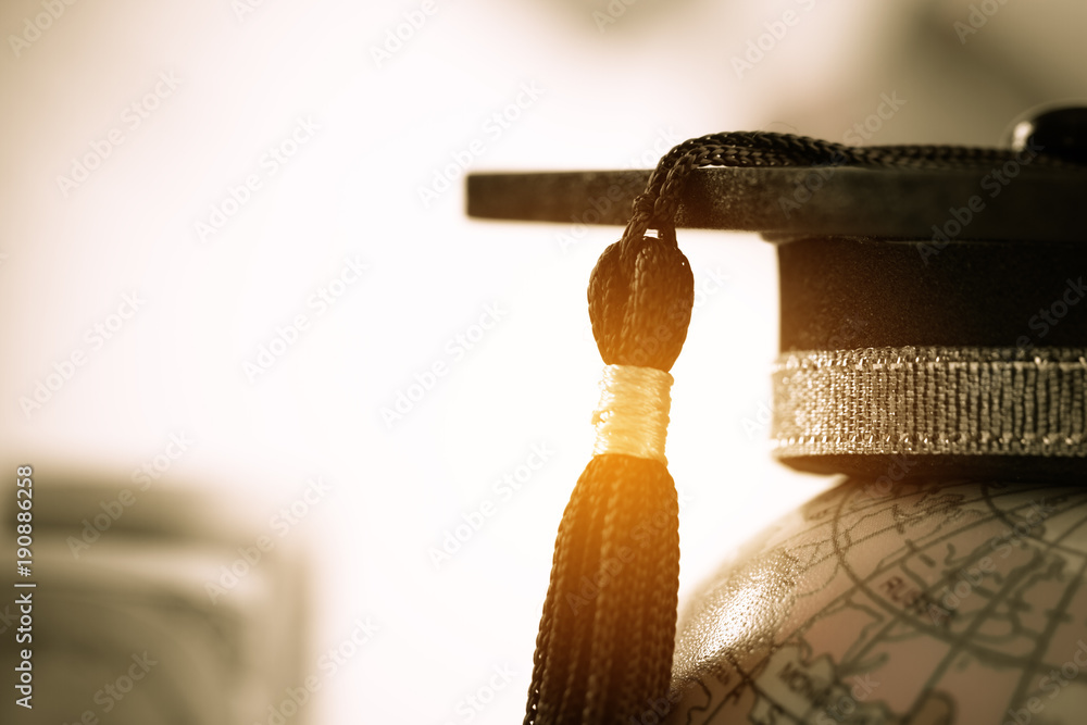 Graduate study abroad concept, Graduation cap on top Earth globe model ...