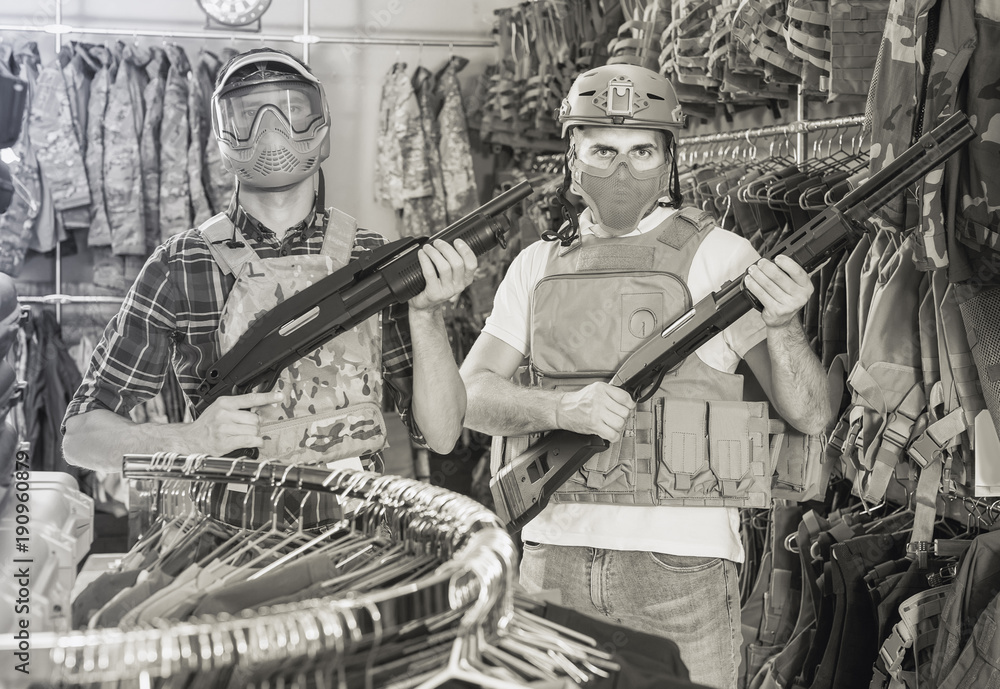 men in army uniform with gun in military market Stock Photo | Adobe Stock