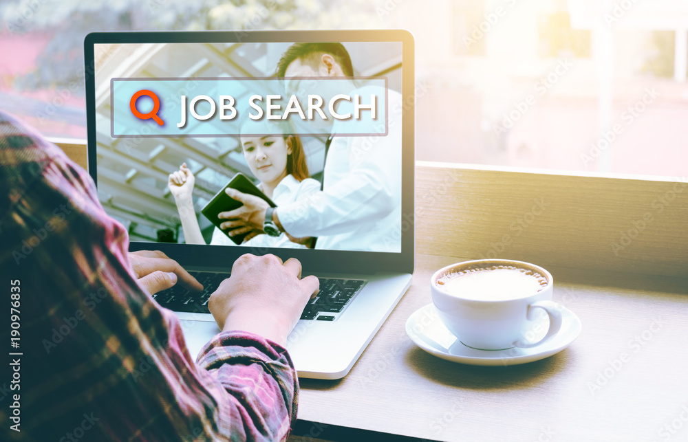 Rear view of people using a laptop computer for job searching and ...