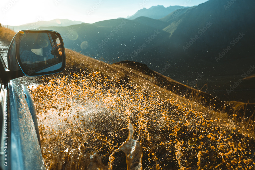 Suv car rides through muddy puddle, off-road track road, with a big ...