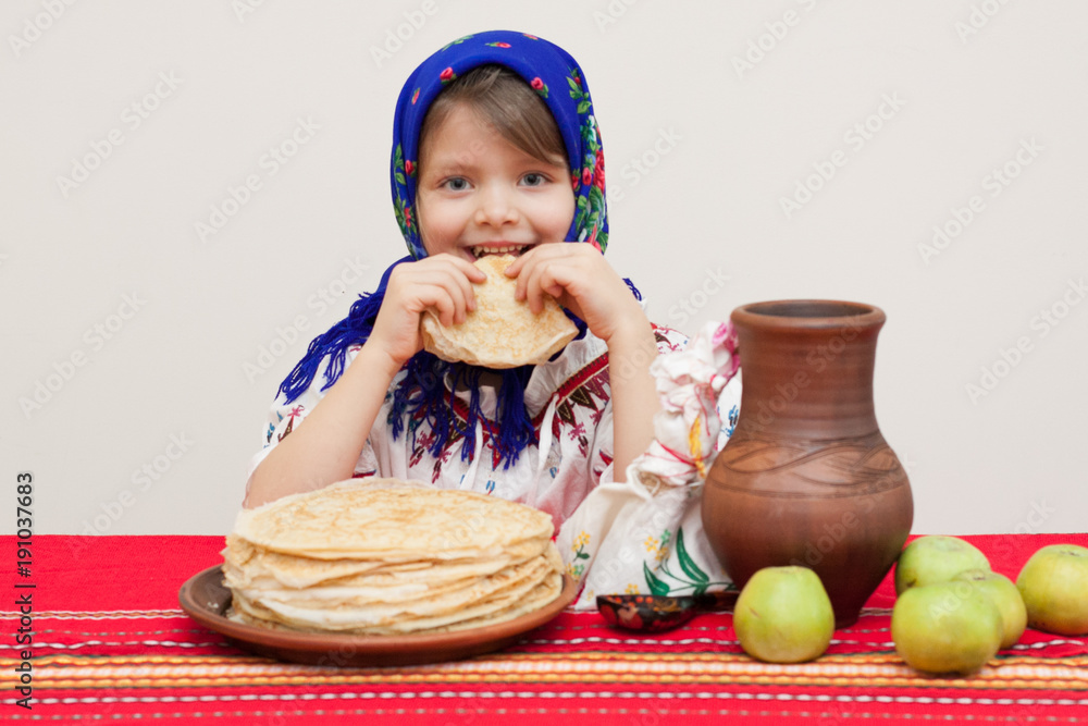 russian girl eating pancakes Stock Photo | Adobe Stock
