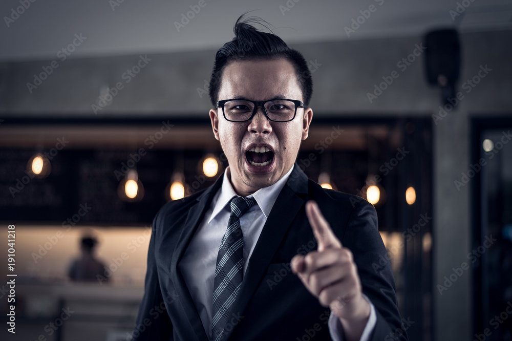 businessman shouting and pointing finger at you because he is very ...