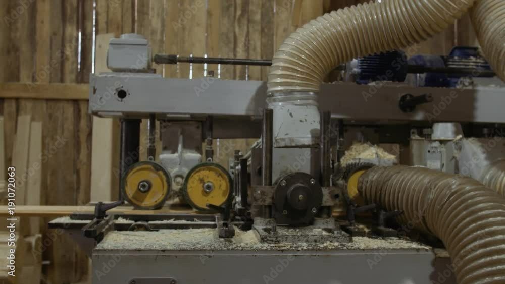Carpenters opertes wood board running out carpenter jointer workbench ...