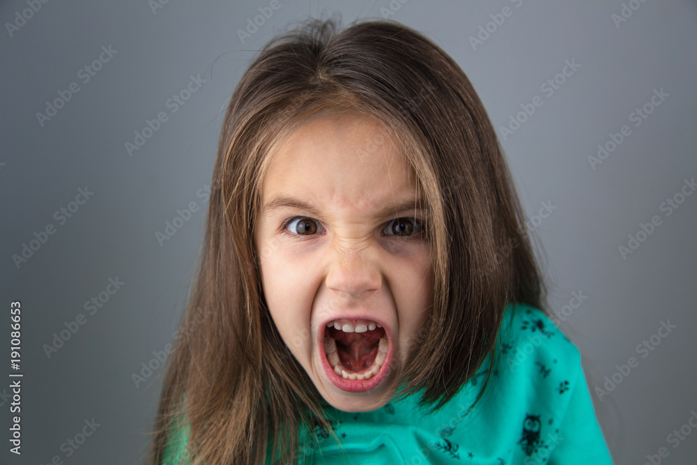 Angry and screaming female child model with grey background Stock Photo ...