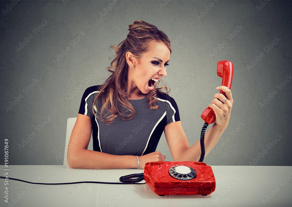 Angry woman screaming in handset Stock Photo | Adobe Stock