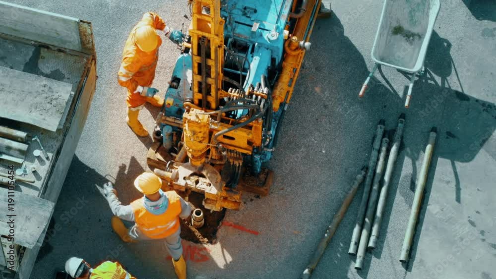 Hydraulic team workers dressed in yellow working clothes and helmet ...