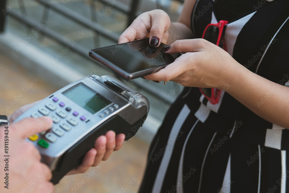 woman use smartphone to make mobile payment with electronic reader ...