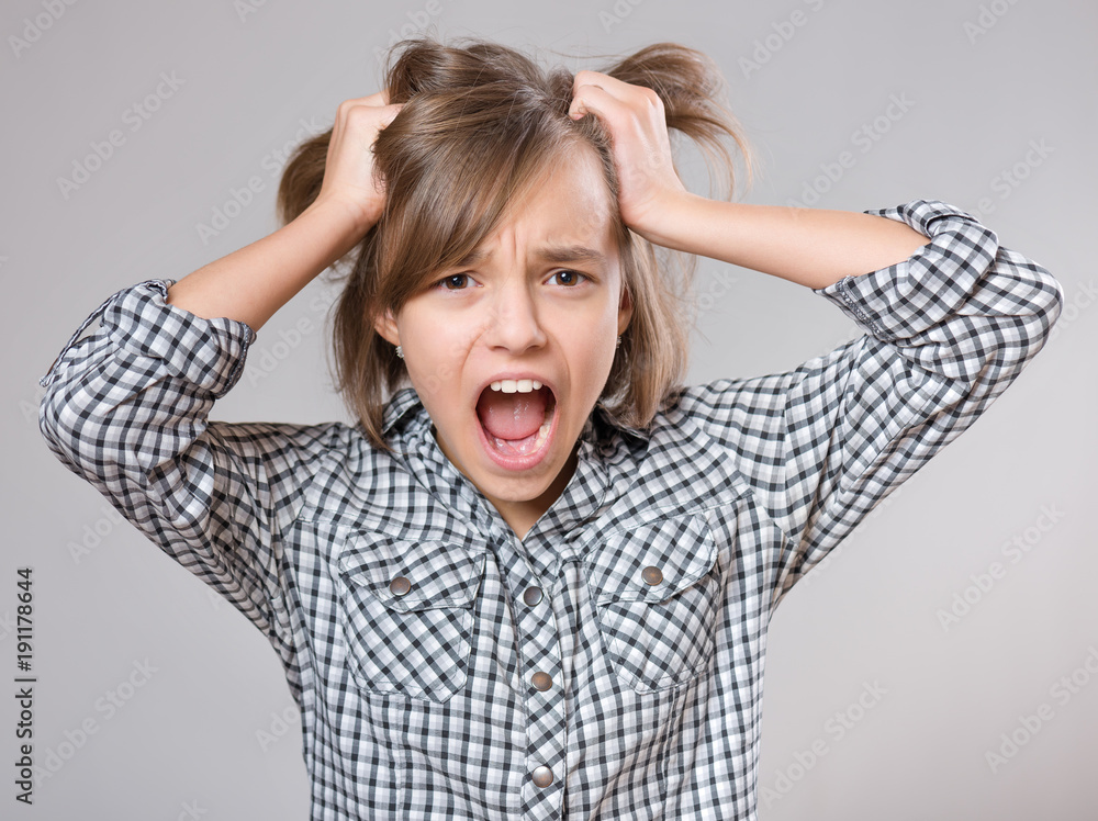 Close-up emotional portrait of attractive angry child teenager girl ...