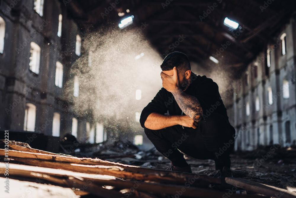 Foto de Sad depressed person in abandoned destroyed building crying ...